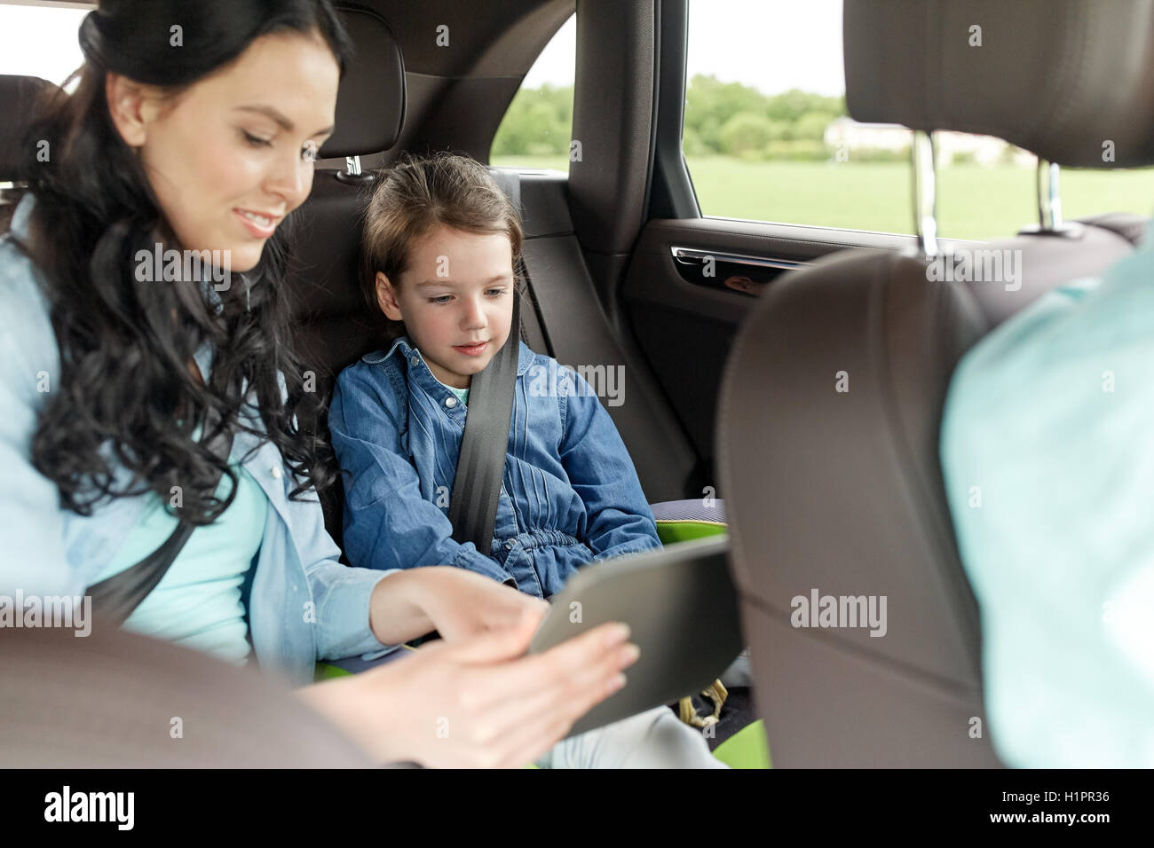 happy family with tablet pc driving in car Stock Photo - Alamy