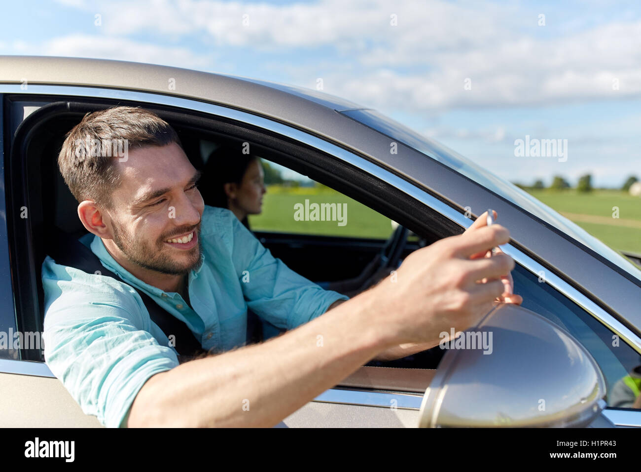 happy smiling man with smartphone driving in car Stock Photo - Alamy