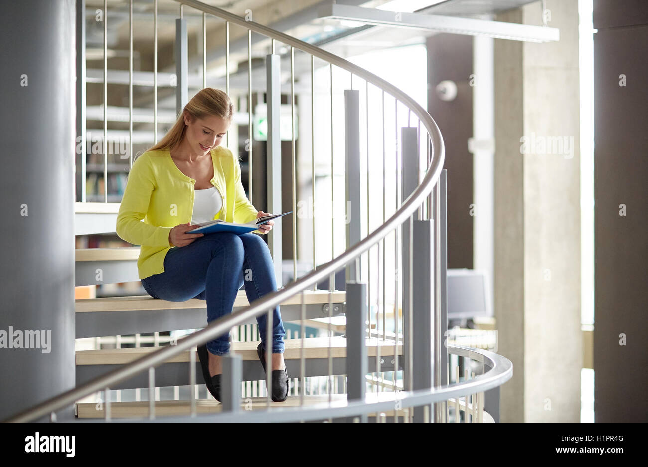 smiling high school student girl reading book Stock Photo - Alamy