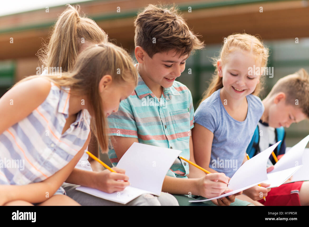 group of happy elementary school students outdoors Stock Photo - Alamy