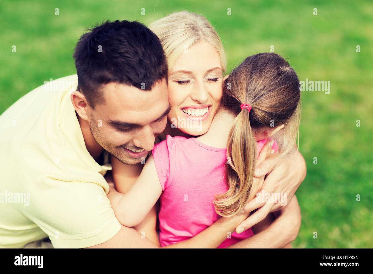 happy family hugging outdoors Stock Photo - Alamy