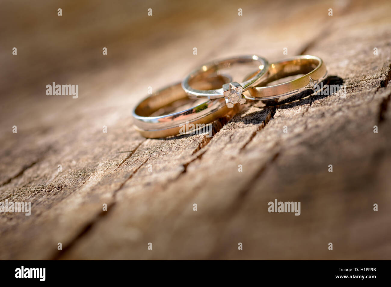 Wedding rings on wooden surface hi-res stock photography and images - Alamy