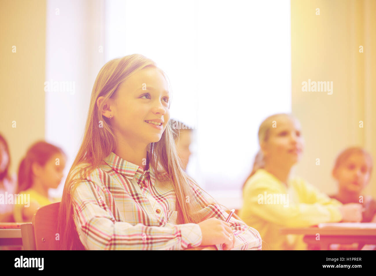 group of school kids with notebooks in classroom Stock Photo - Alamy