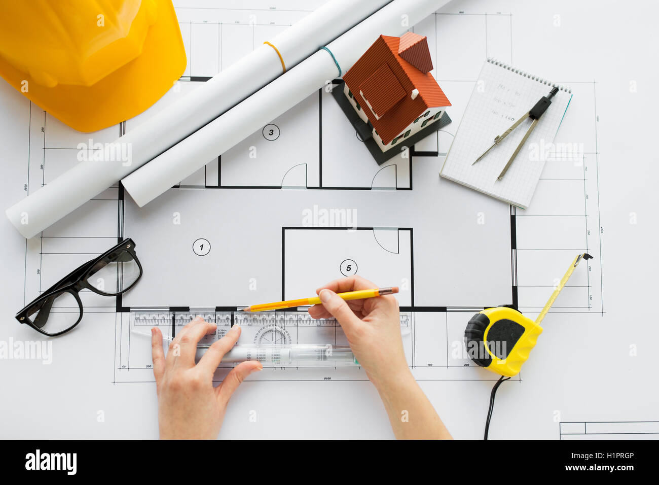 close up of hands with ruler measuring blueprint Stock Photo - Alamy