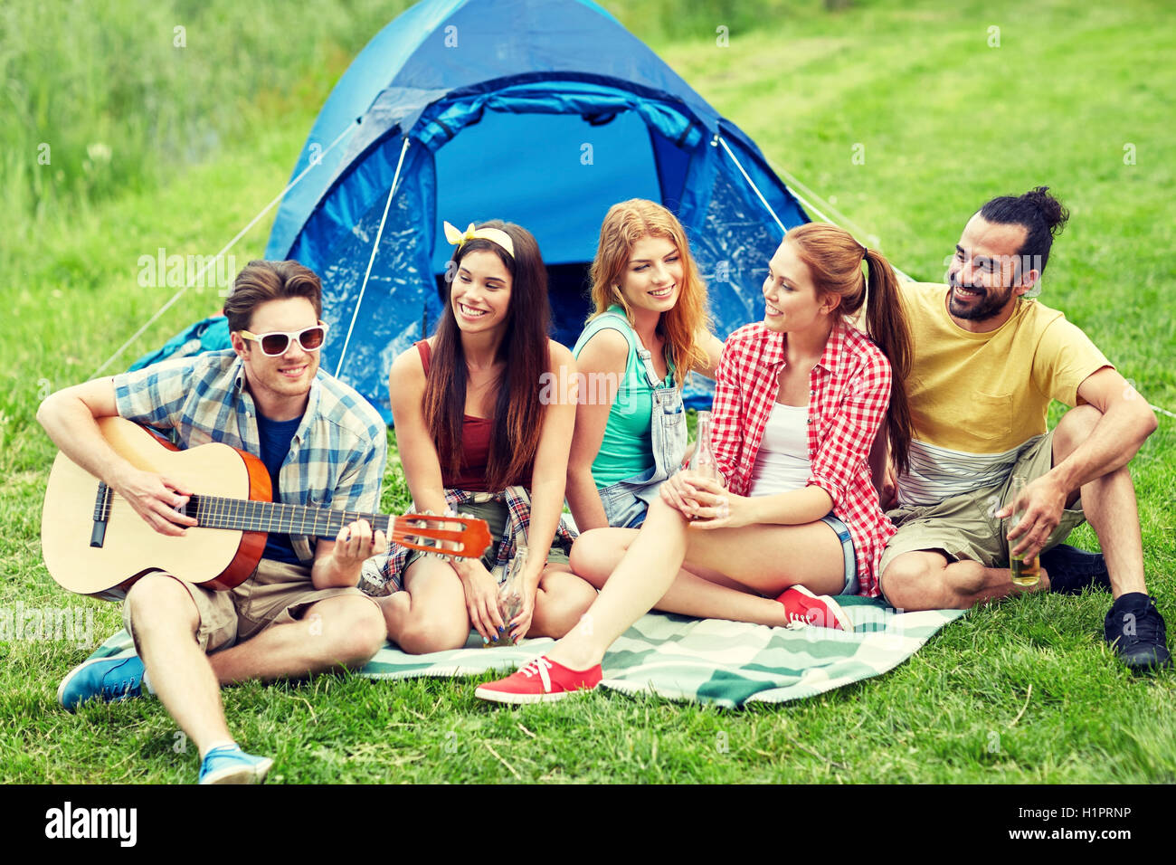 happy friends with drinks and guitar at camping Stock Photo - Alamy