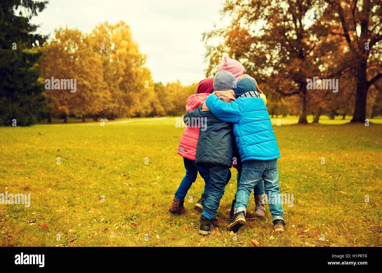 group of happy children hugging in autumn park Stock Photo - Alamy