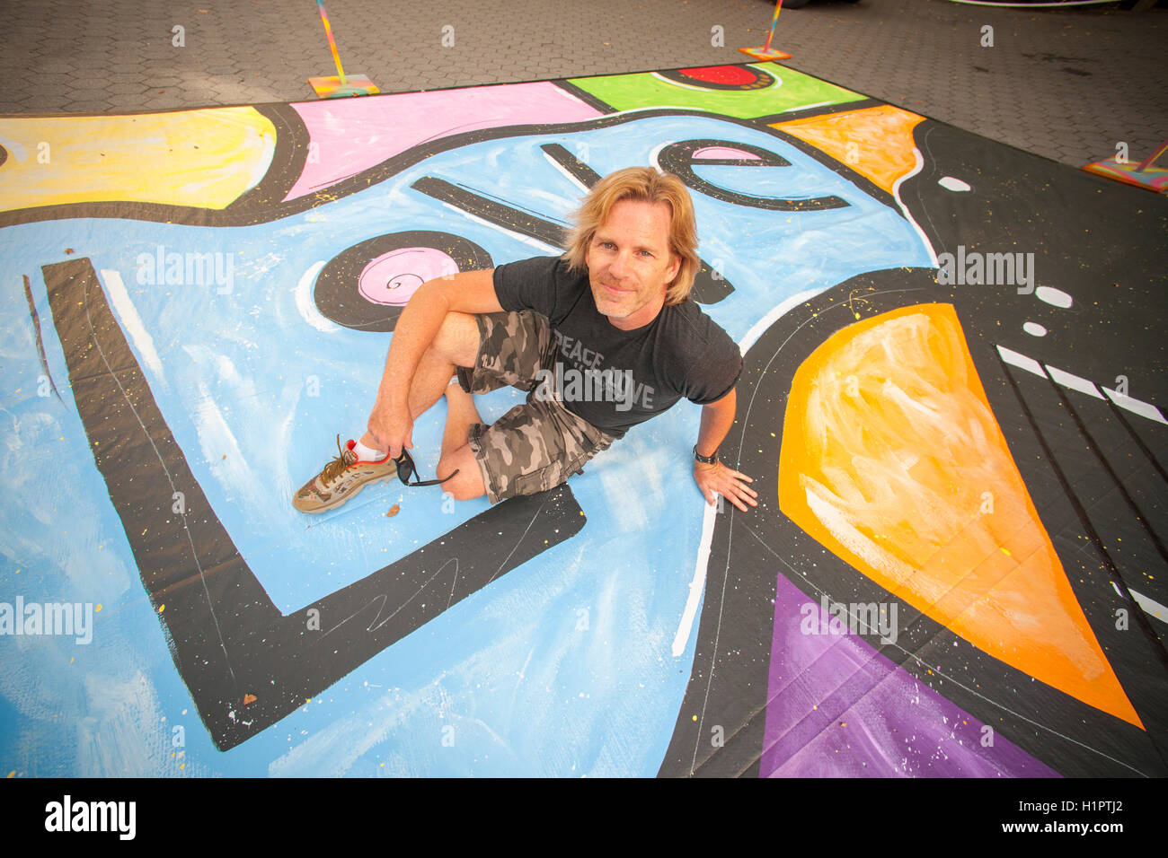 The artist Eric Waugh poses in his 2500 square foot painting featuring ...