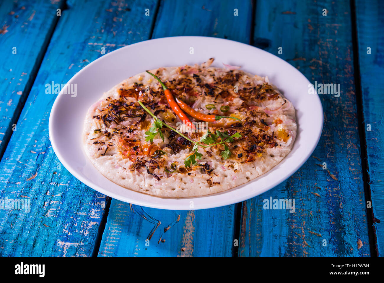 South Indian Food Uttapam or ooththappam or Uthappa is a dosa-like dish ...