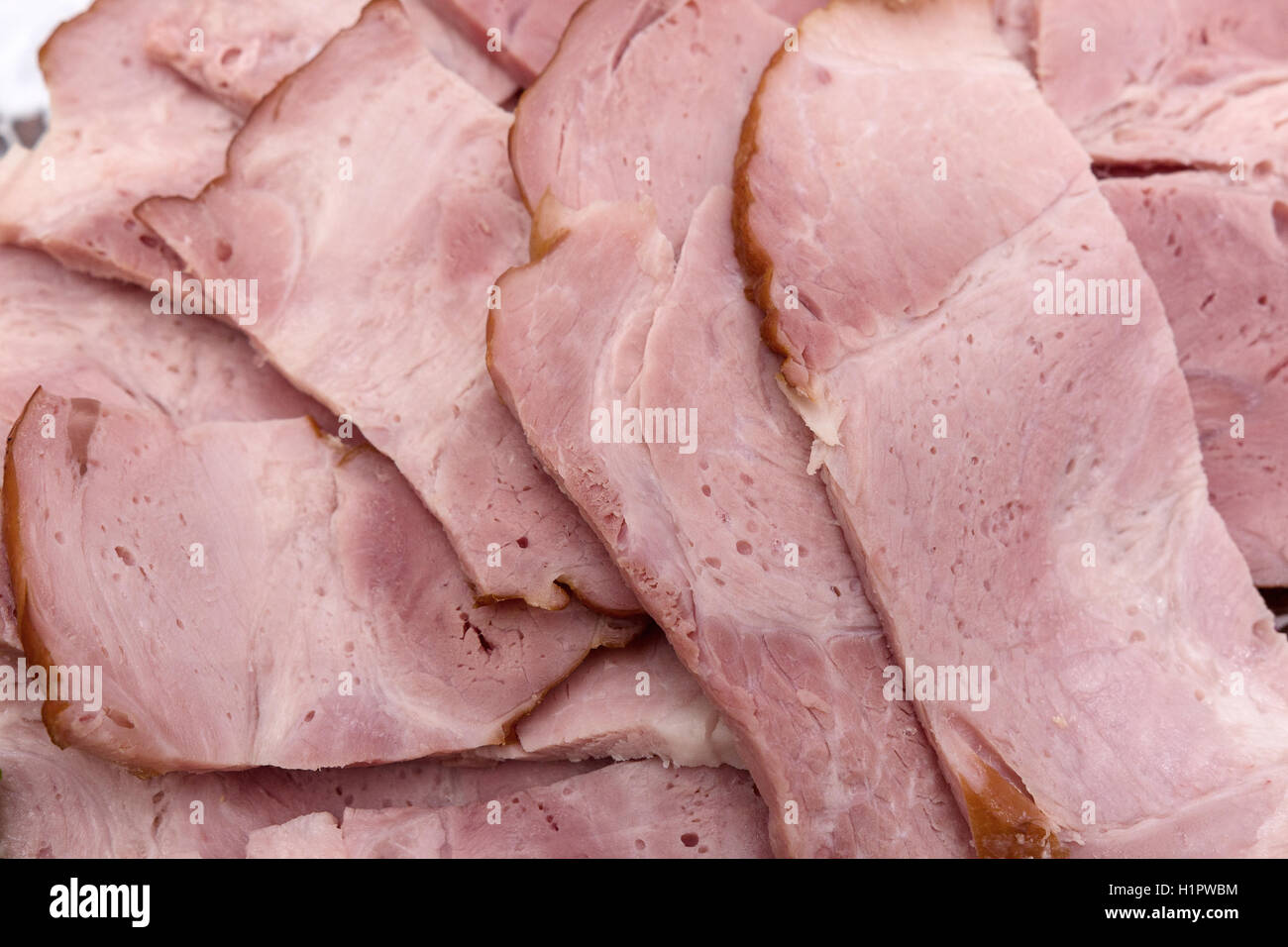 carefully cut into square pieces of ham Stock Photo - Alamy