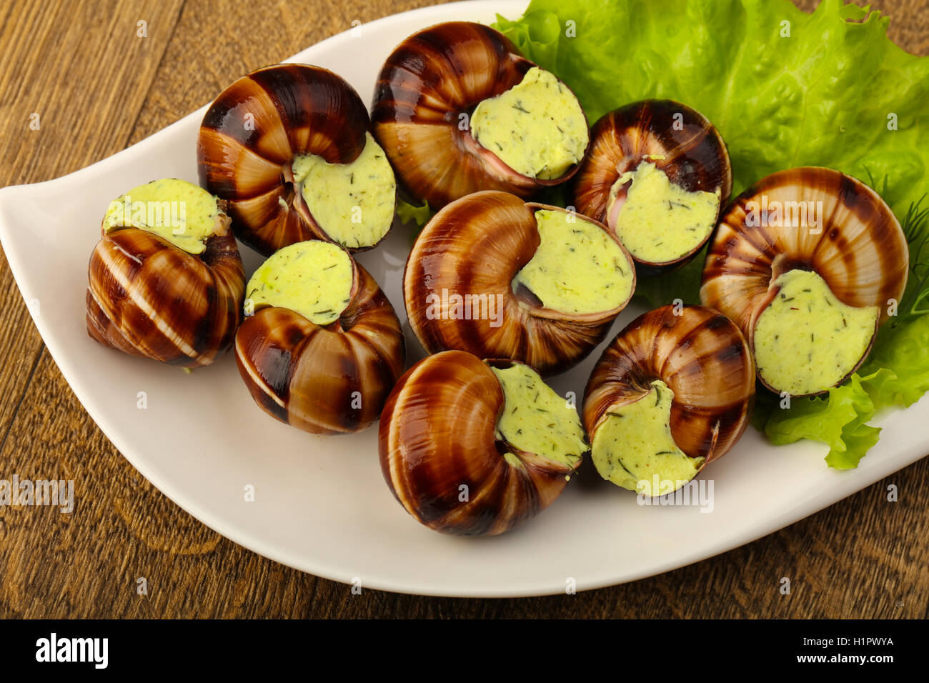 Escargot with cheese cream on salad leaves Stock Photo - Alamy
