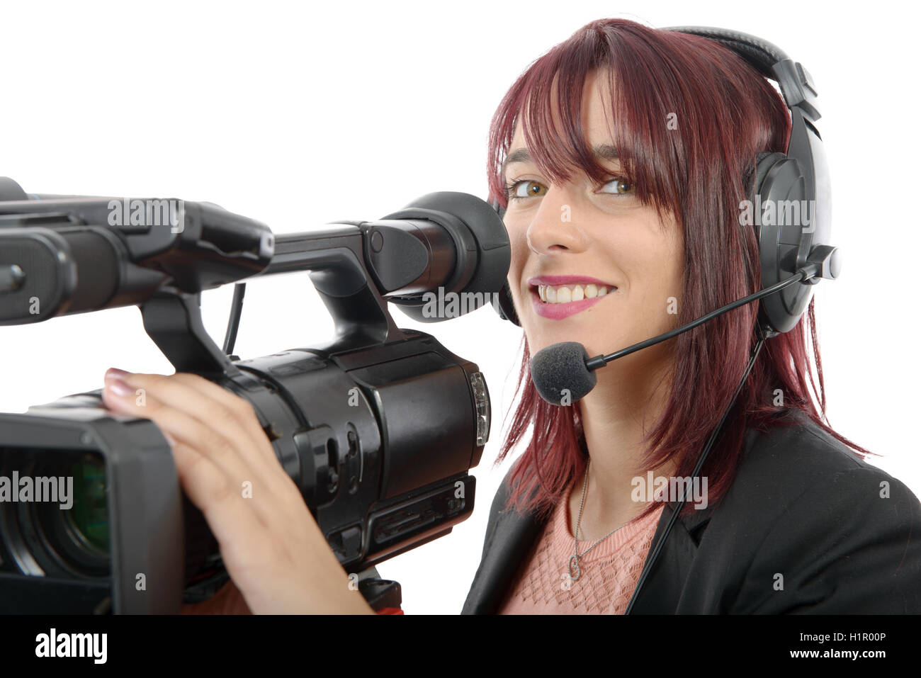 a beautiful young woman with a professional video camera and headphone ...