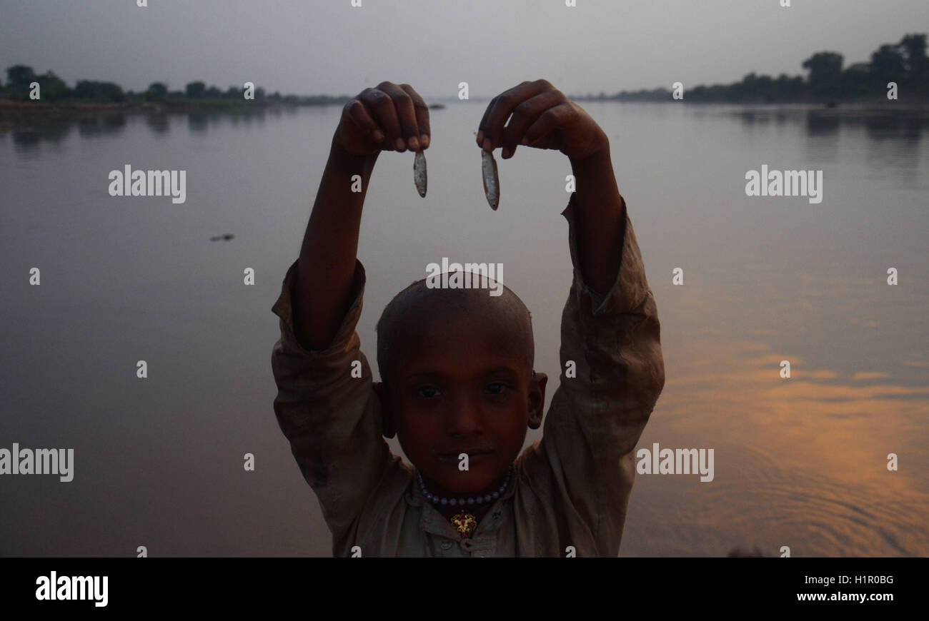 Lahore, Pakistan. 23rd Sep, 2016. Pakistani gypsy children busy fishing ...