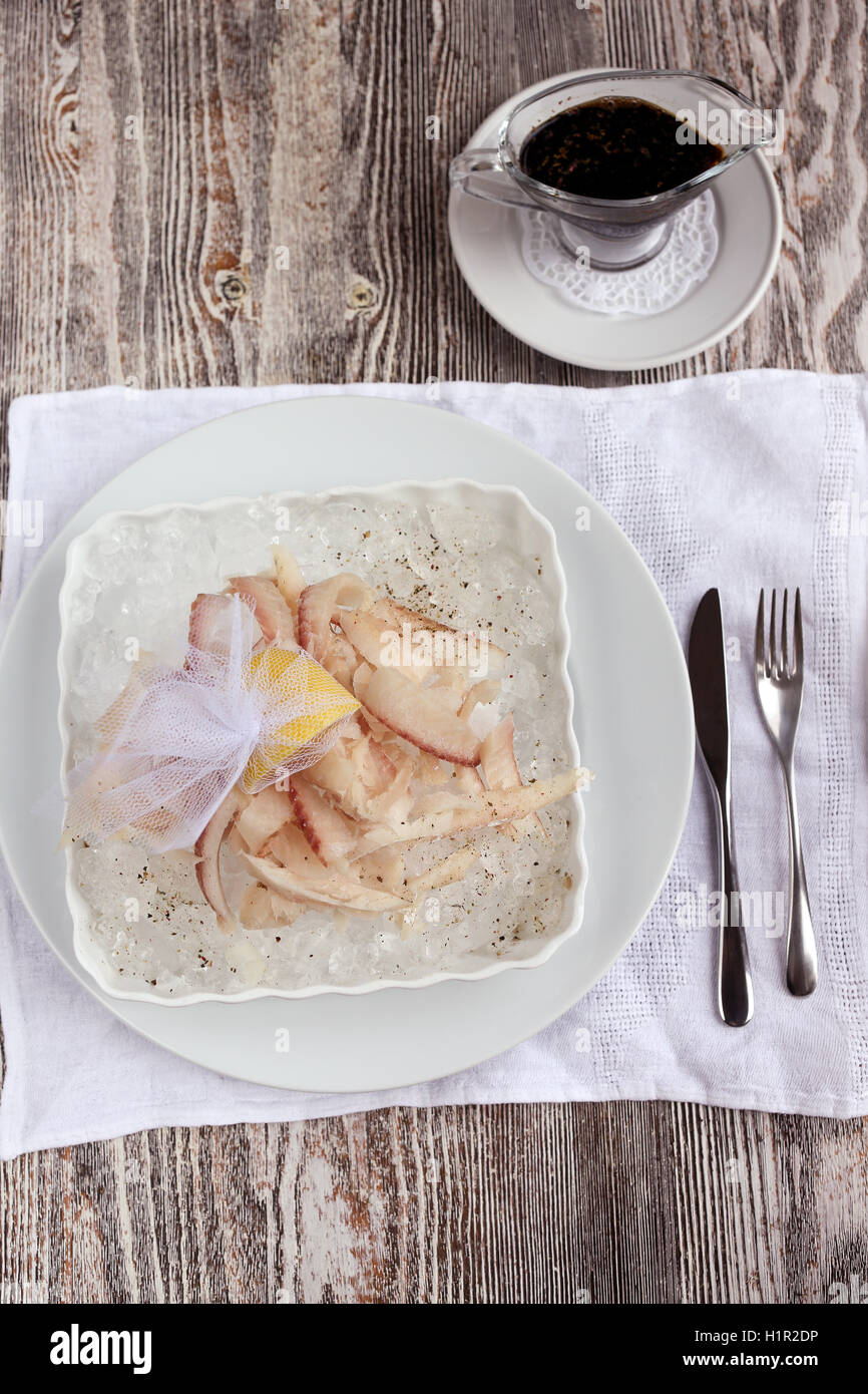 Sliced raw frozen fish with ice Stock Photo - Alamy