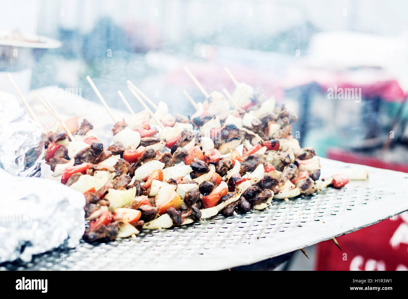 Pieces of meat bitten on wood cook on a hot grill Stock Photo - Alamy