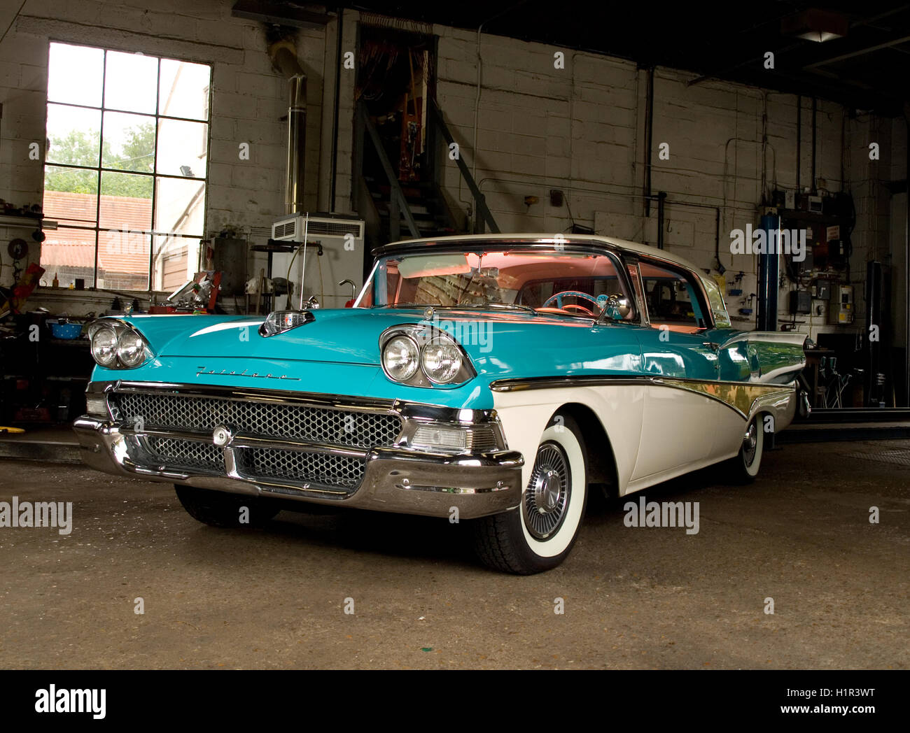 A 1958 Ford Fairlane Skyliner Retractable in a garage workshop setting ...