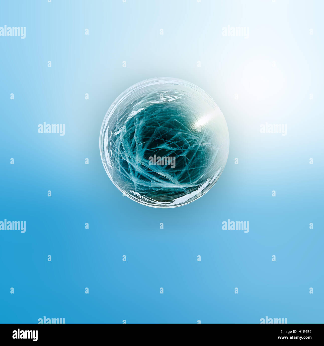 Blue ice sphere covered with cracks on a blue background, the ...