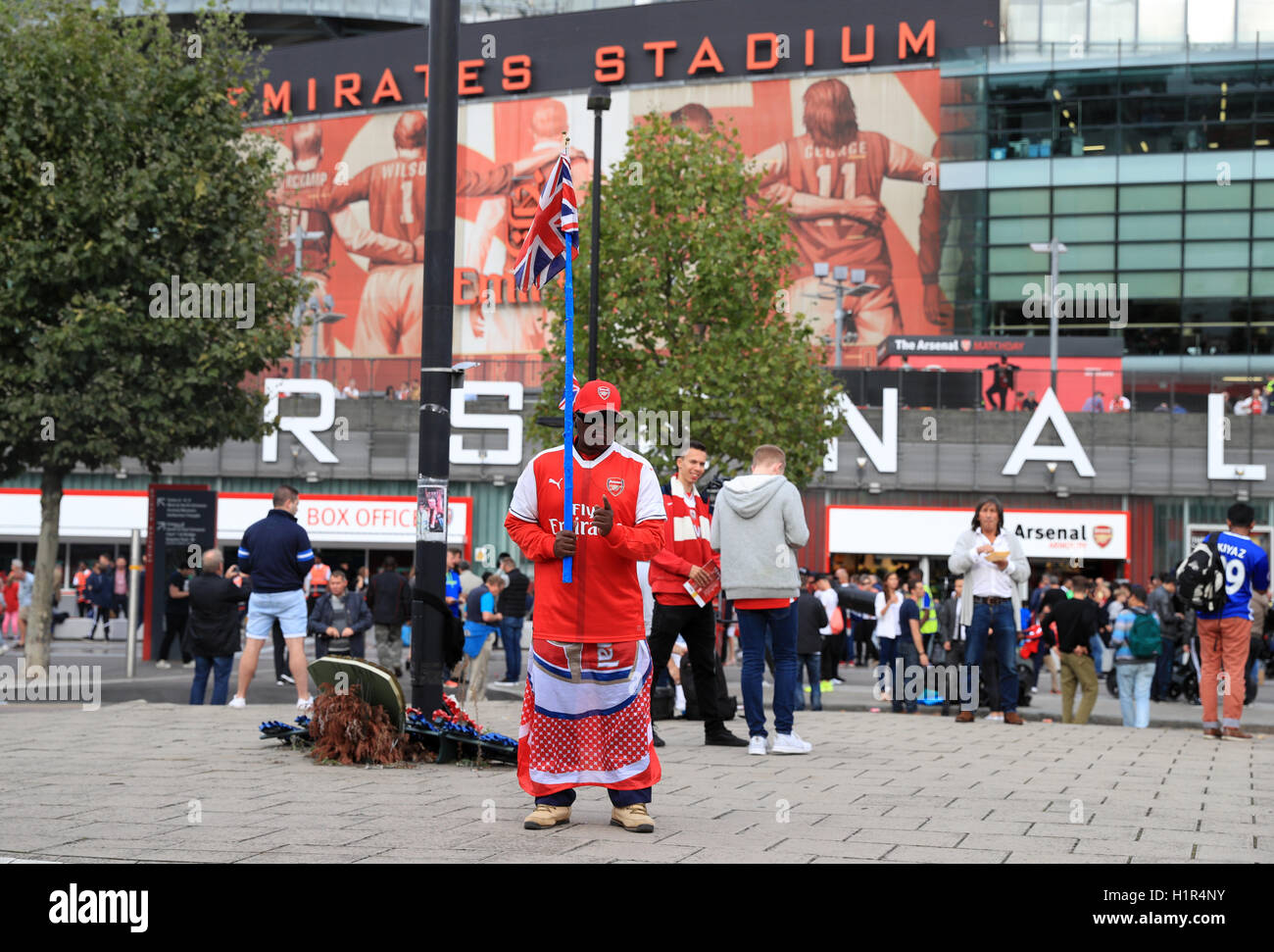 An Arsenal fan outside the ground before the Premier League match at ...