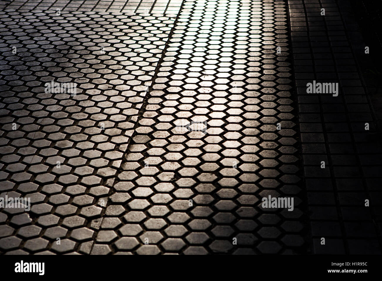 Abstarct patterns in the pavement with tiled floor shadows and sunshine ...