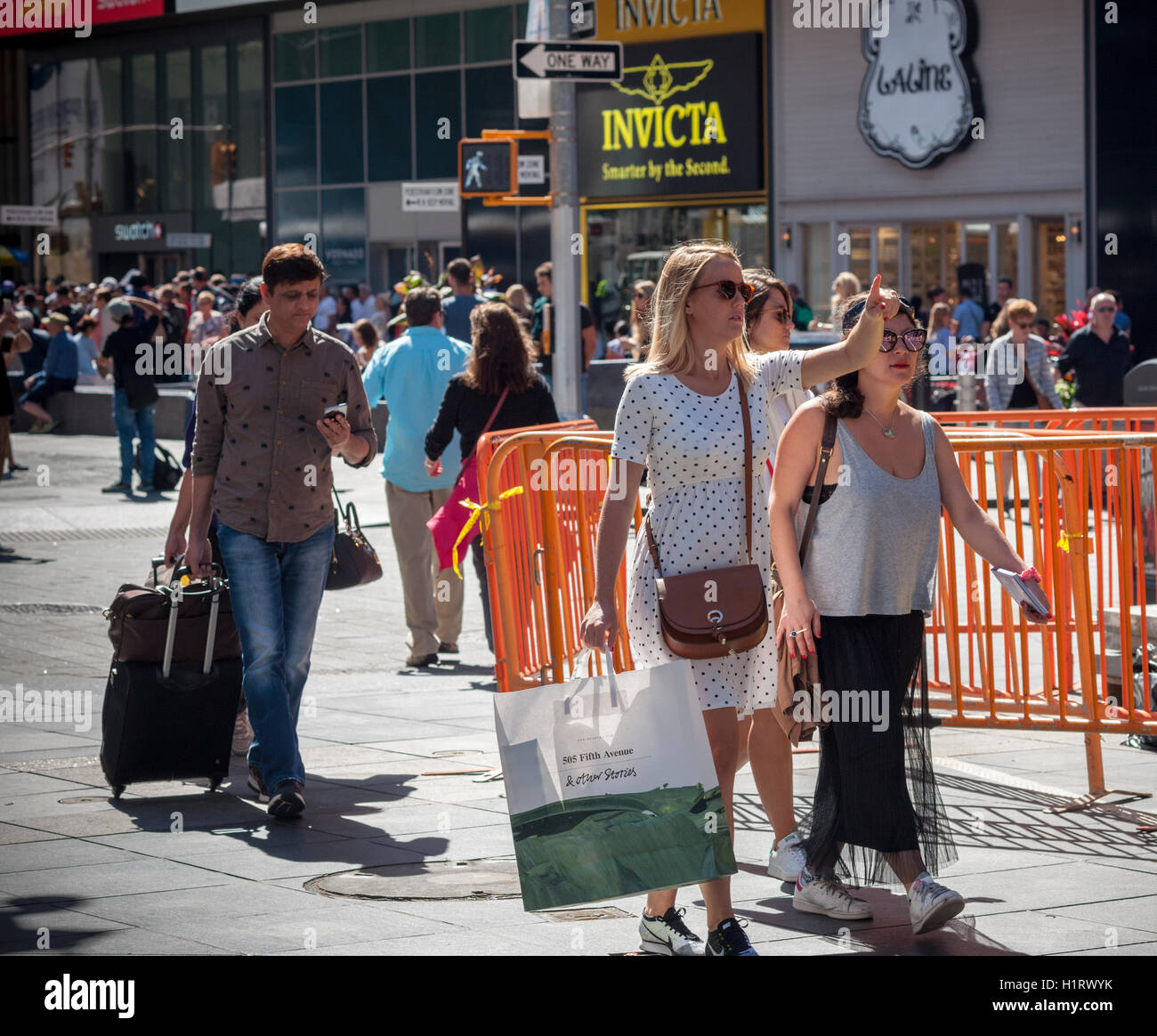 Visitor to Times Square in New York with her & Other Stories purchases ...