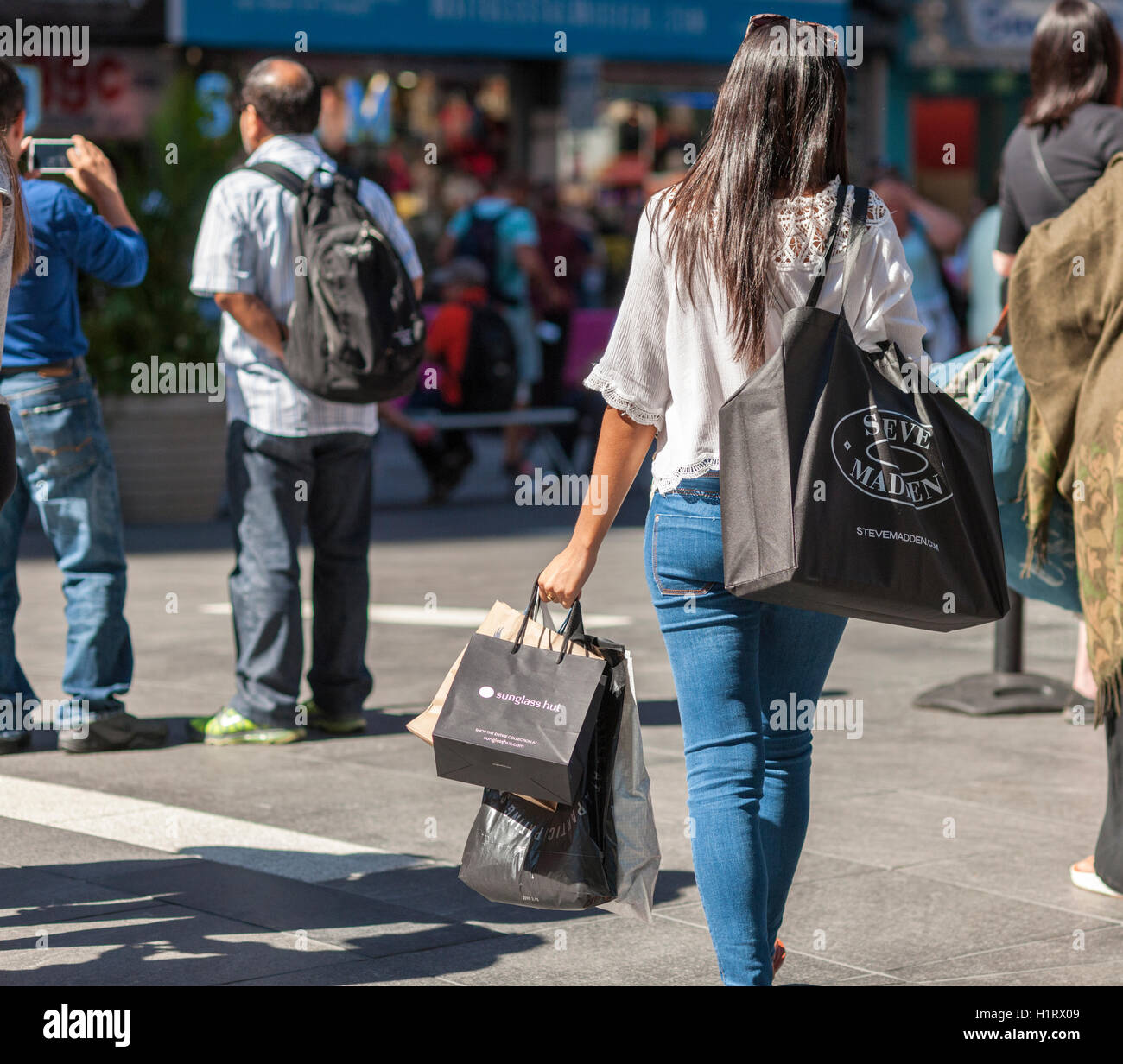 Visitor to Times Square in New York with her purchases on Thursday ...