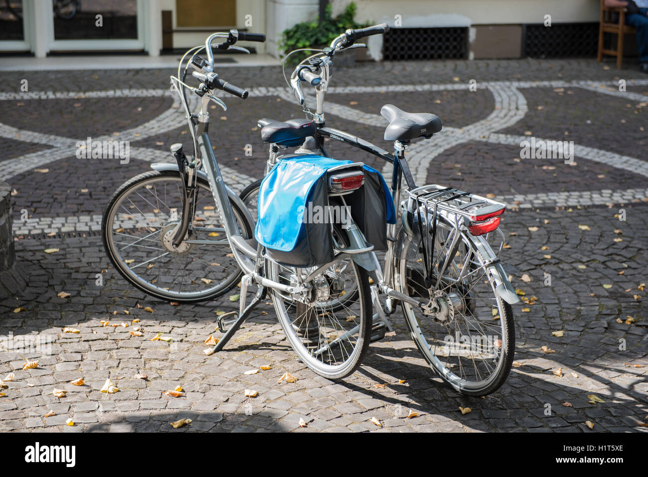 two bycicles standing on the street in the sun Stock Photo - Alamy