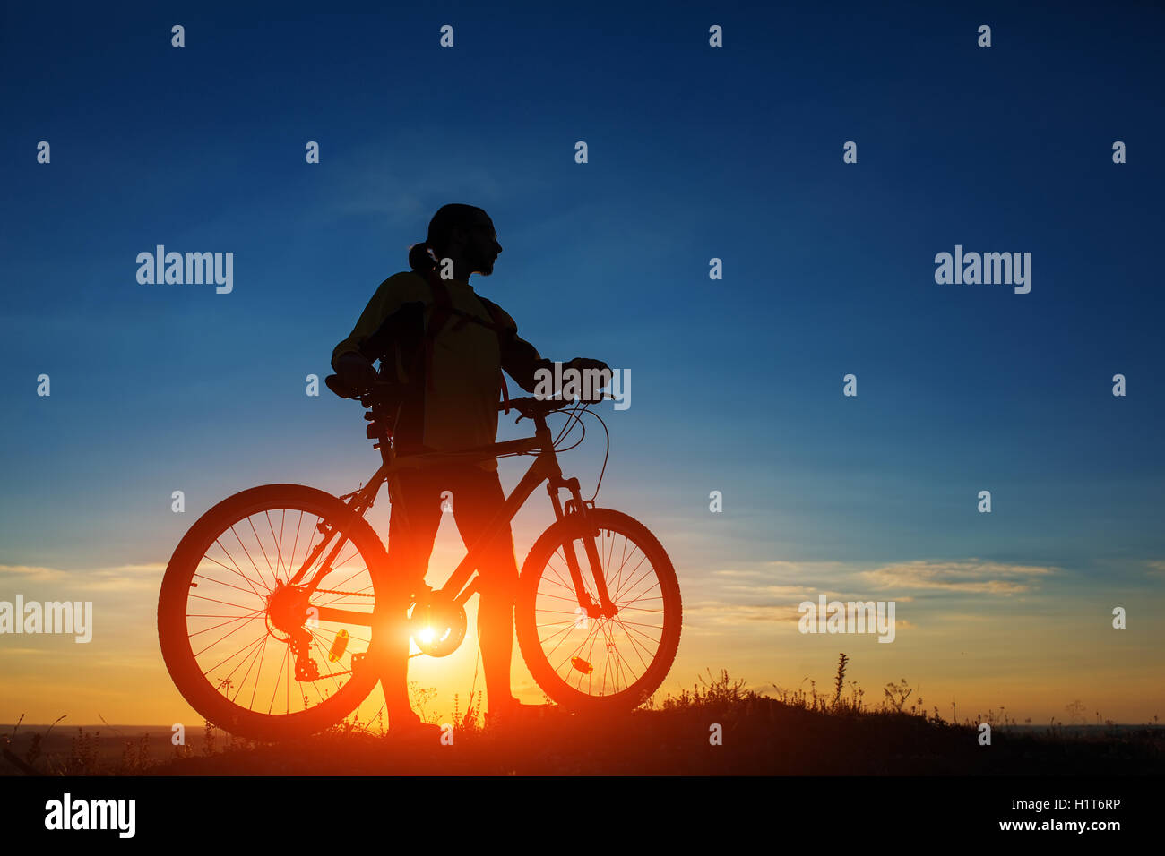 Silhouette of a bike on sky background on sunset Stock Photo - Alamy