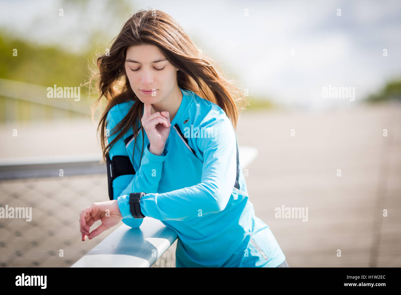 Woman checking her pulse after exercising Stock Photo - Alamy