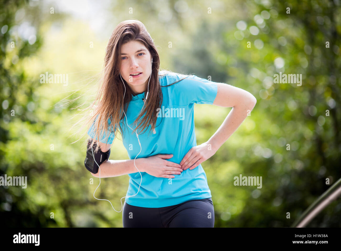 Woman suffering from a stitch Stock Photo - Alamy