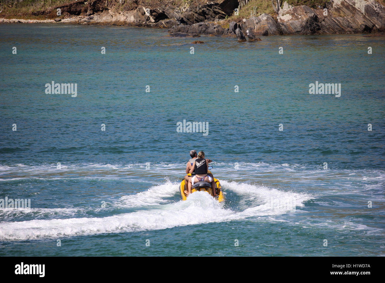 Couple riding jet ski in the sea in Cabo Frio, Rio de Janeiro, Brazil ...