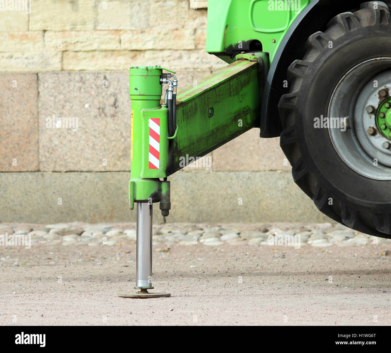 Truck strong outrigger stabilizing legs extended. Boom lifts building ...