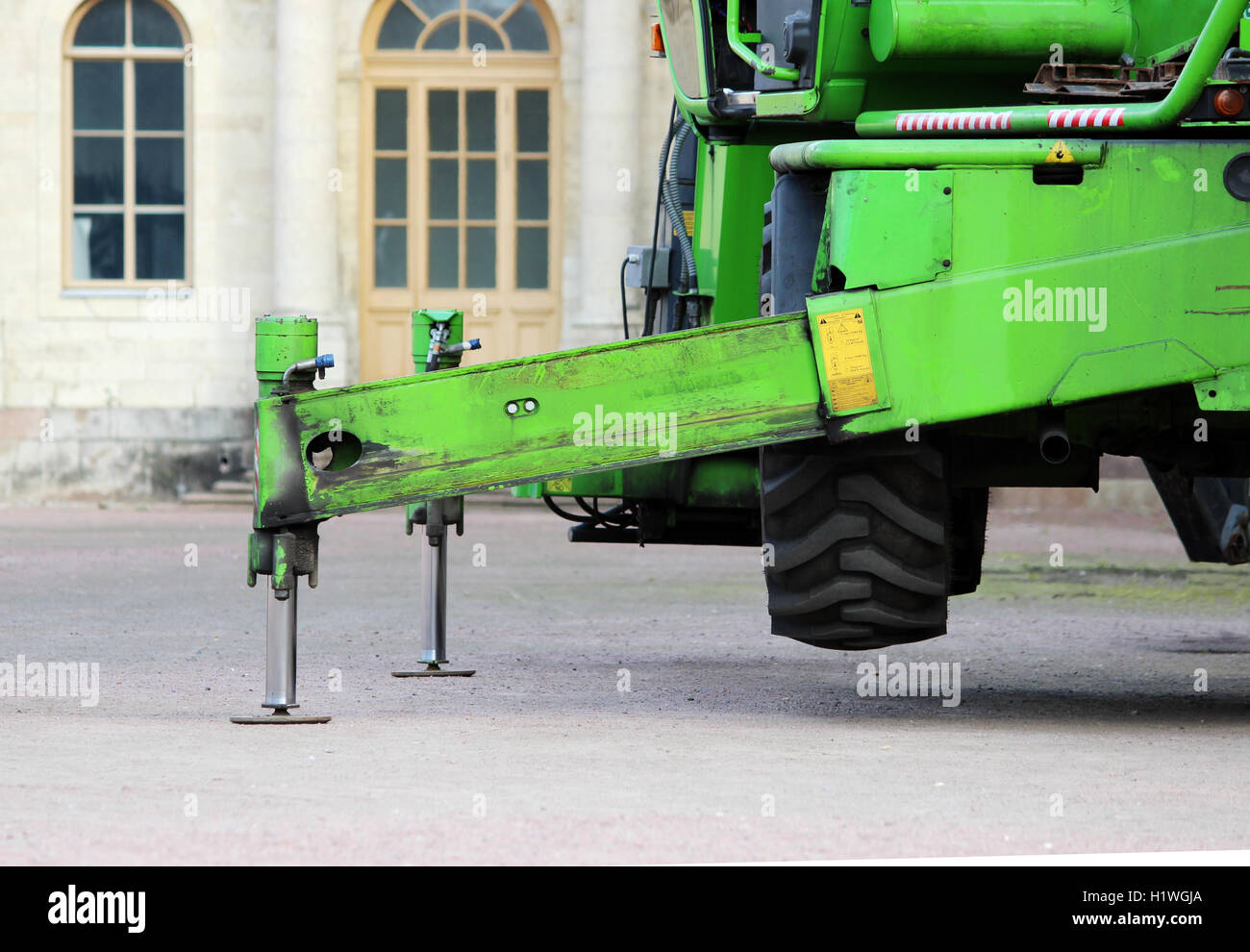 Truck strong outrigger stabilizing legs extended. Boom lifts building ...