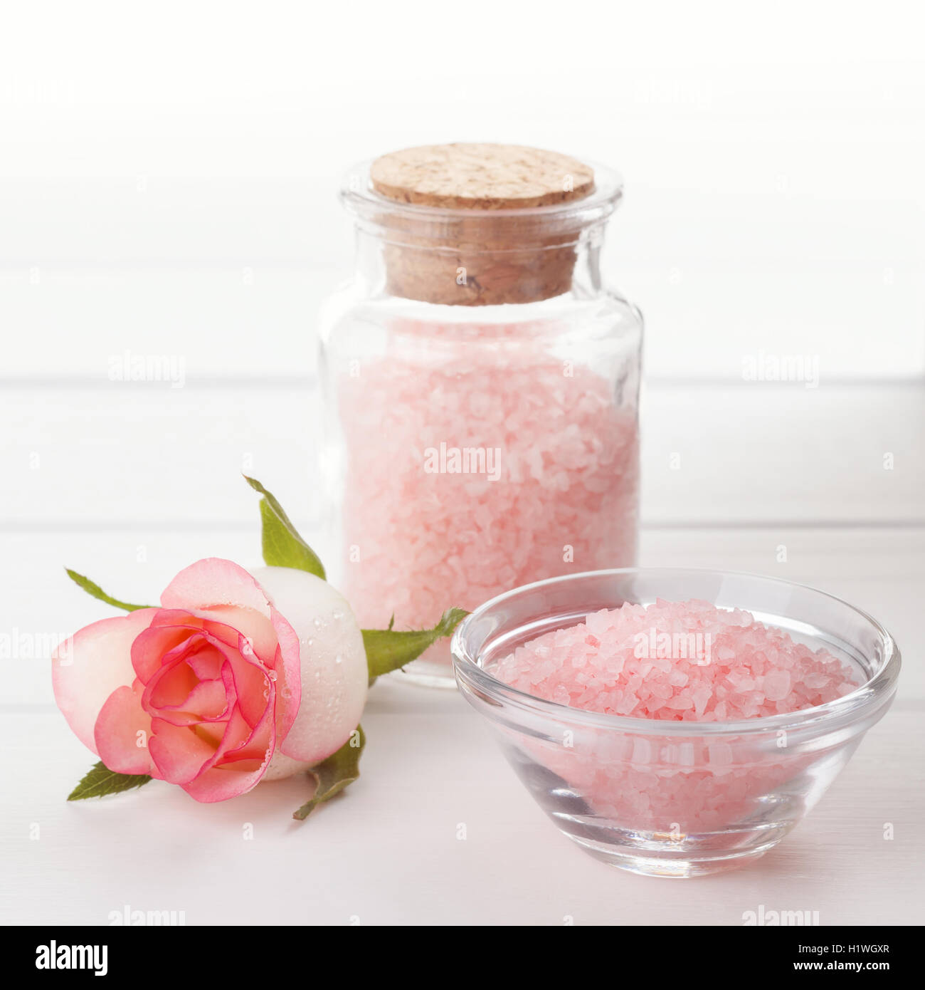 Pink rose bath salt, close up over white background, selective focus ...