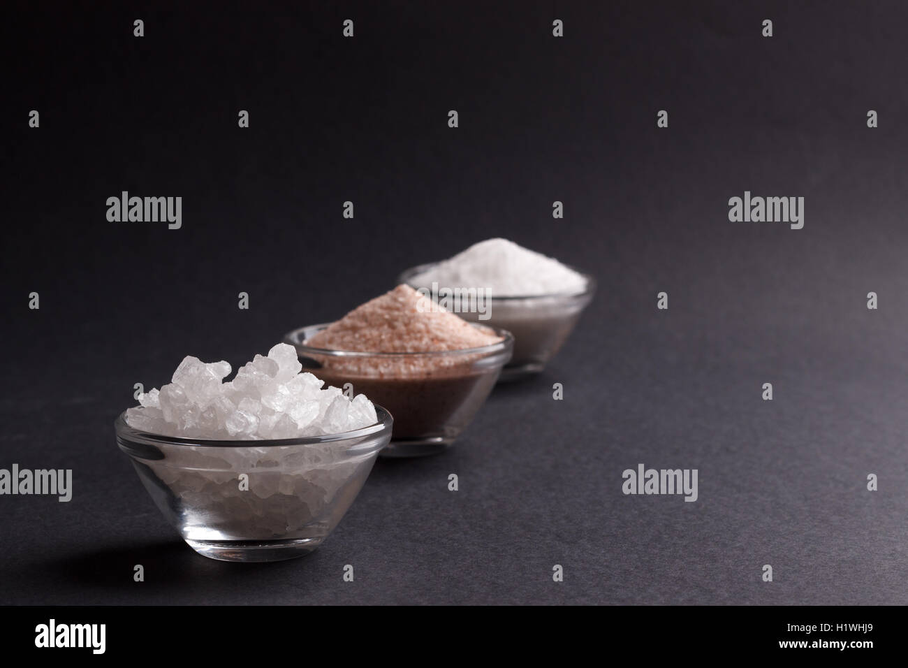 Three types of salt on dark background, selective focus Stock Photo - Alamy