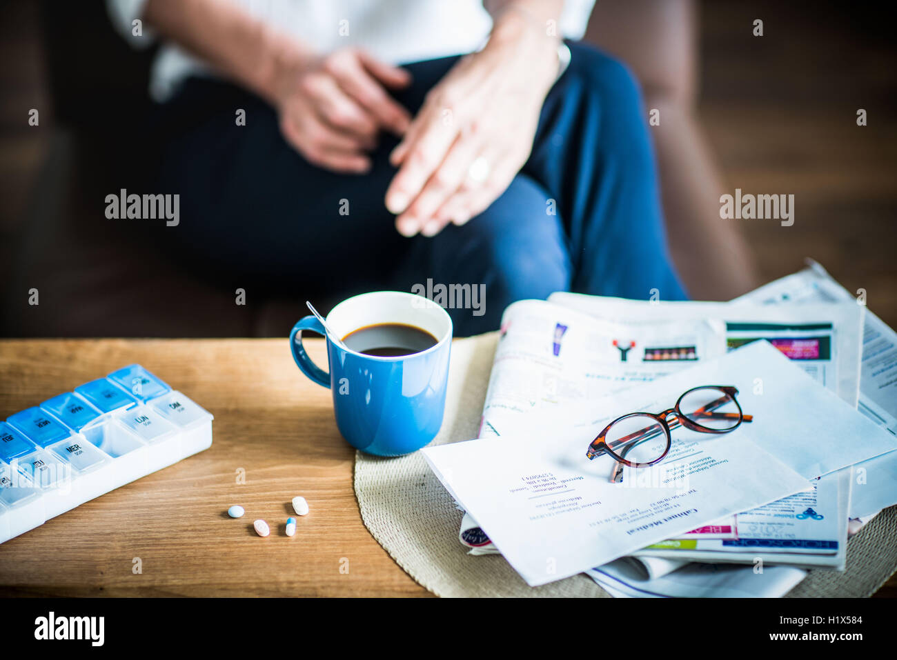 Woman taking medication from a pillbox Stock Photo - Alamy