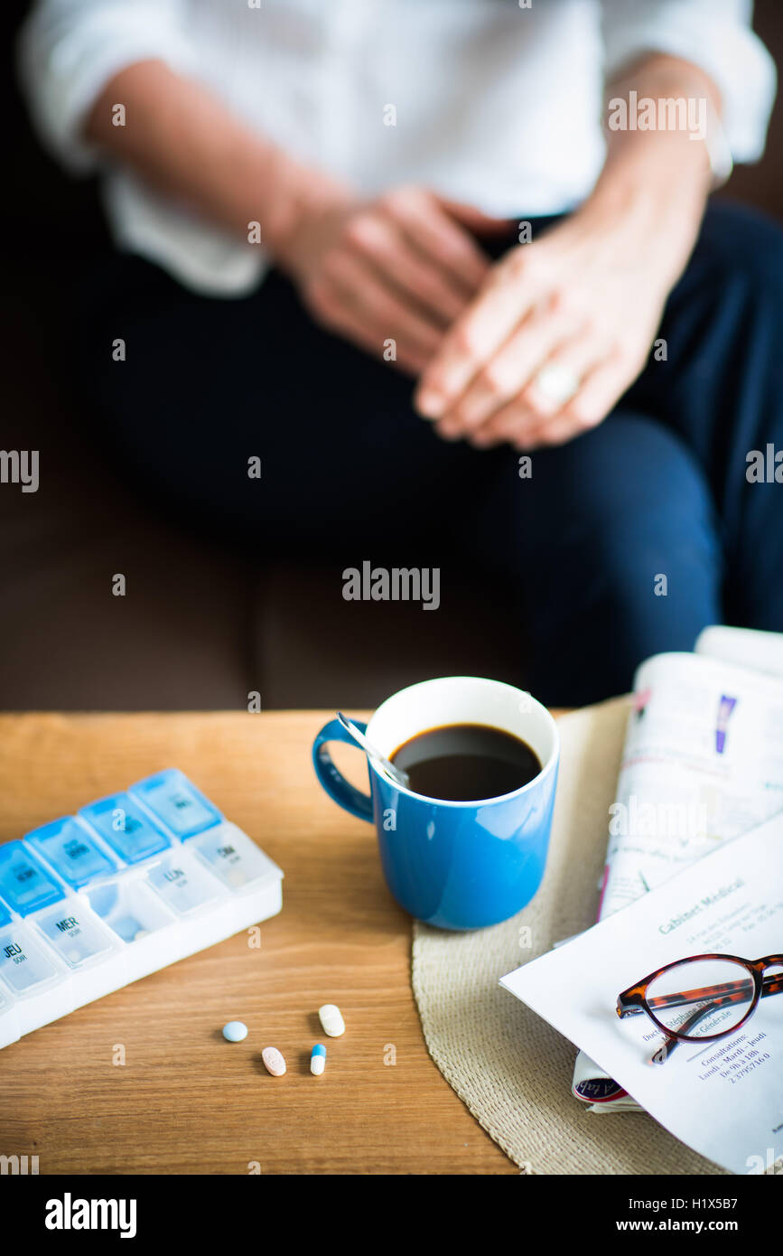 Woman taking medication from a pillbox Stock Photo - Alamy