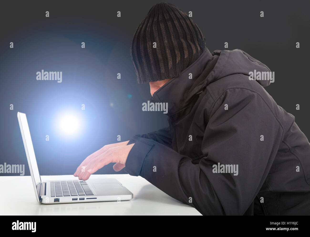 hacker working with a laptop computer in the darkness Stock Photo - Alamy