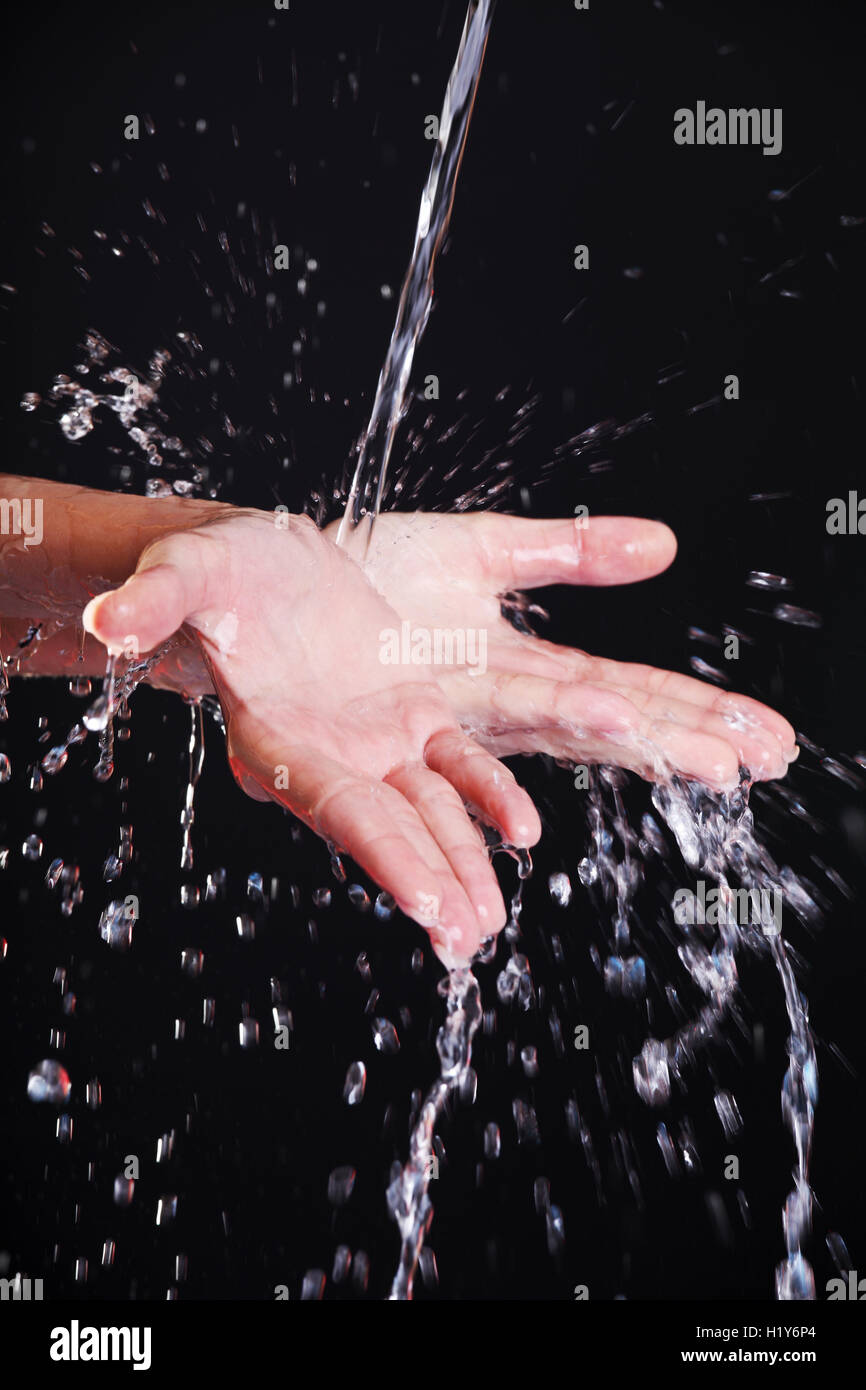 Water falling on female hands Stock Photo - Alamy