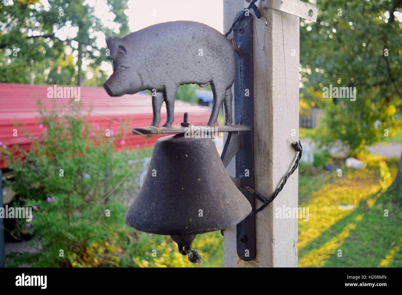 A pig bell on a porch Stock Photo - Alamy