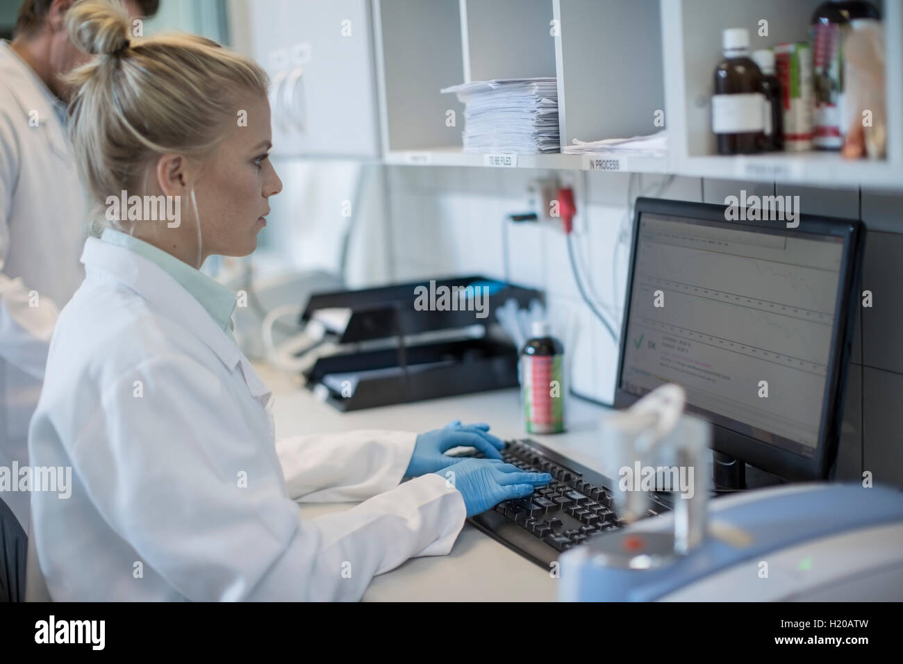 Young woman working on computer in lab Stock Photo - Alamy
