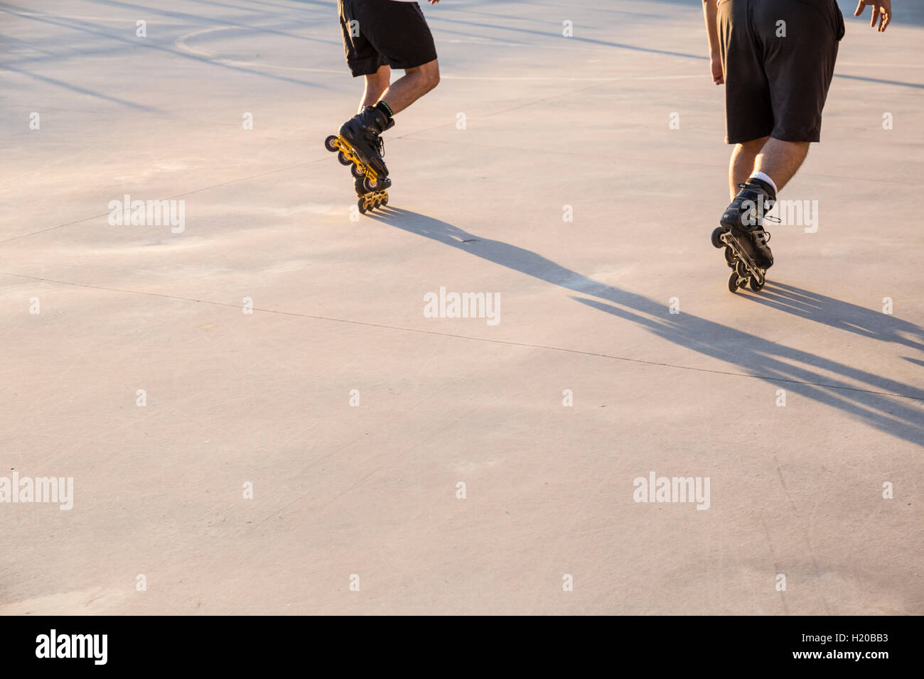 Legs of men with rollerblades skating Stock Photo - Alamy