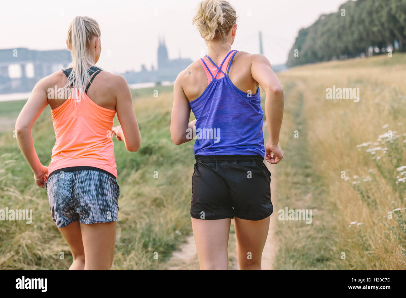 Sportive young woman running on meadow hi-res stock photography and ...