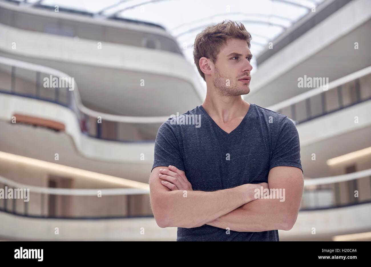 Young man in modern office building Stock Photo - Alamy