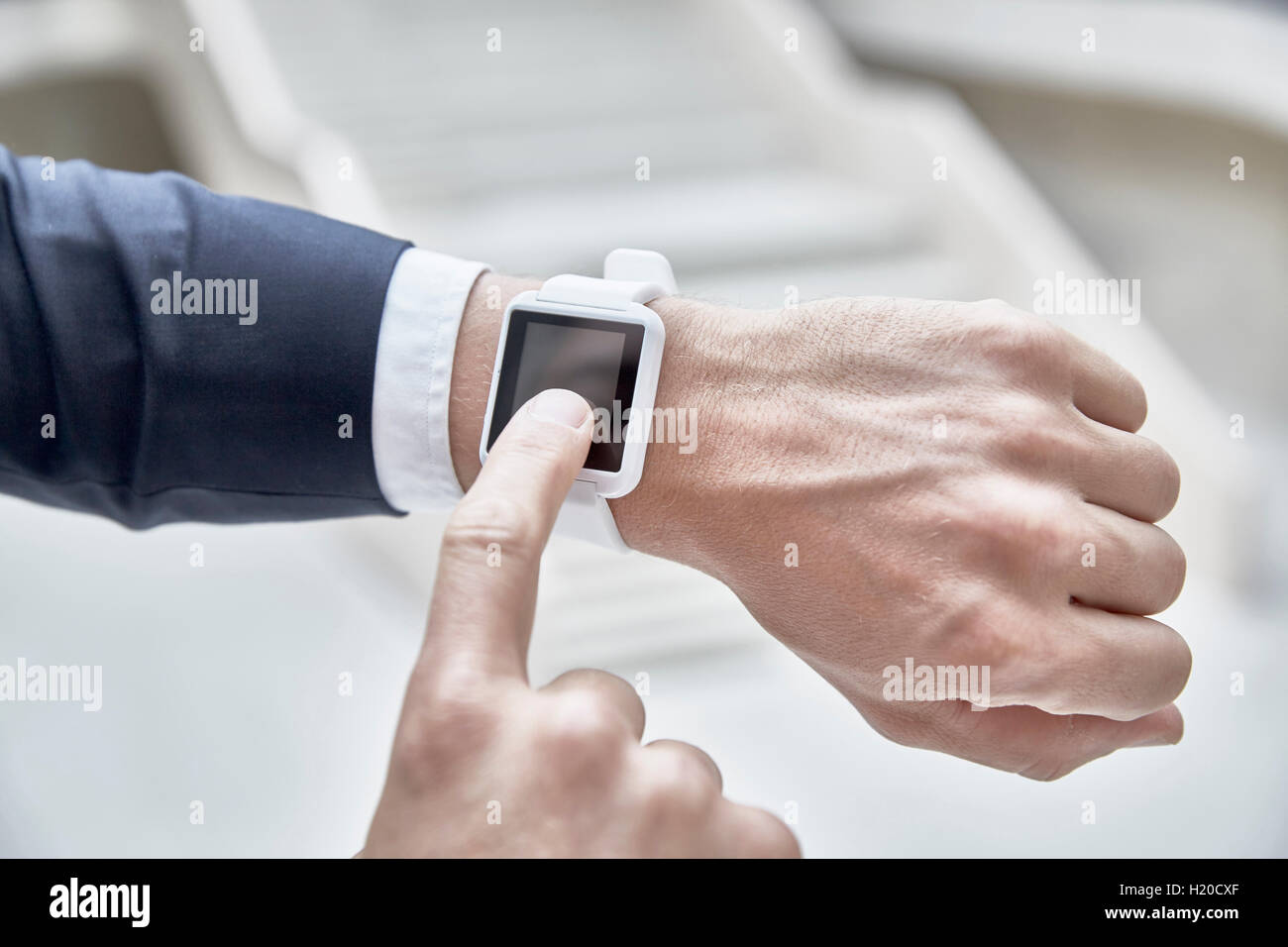 Businessman touching smartwatch Stock Photo - Alamy