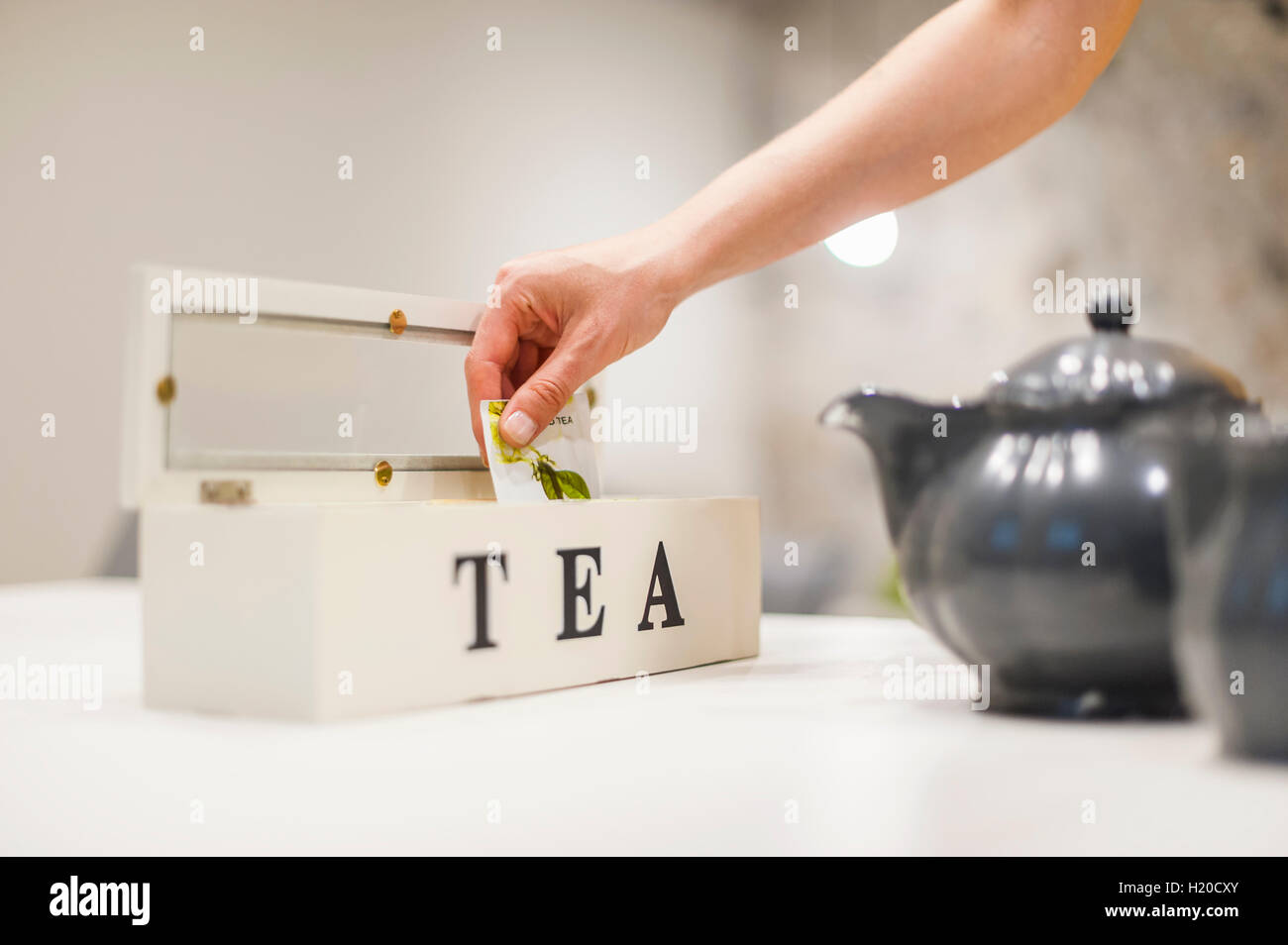 Woman preparing tea Stock Photo - Alamy