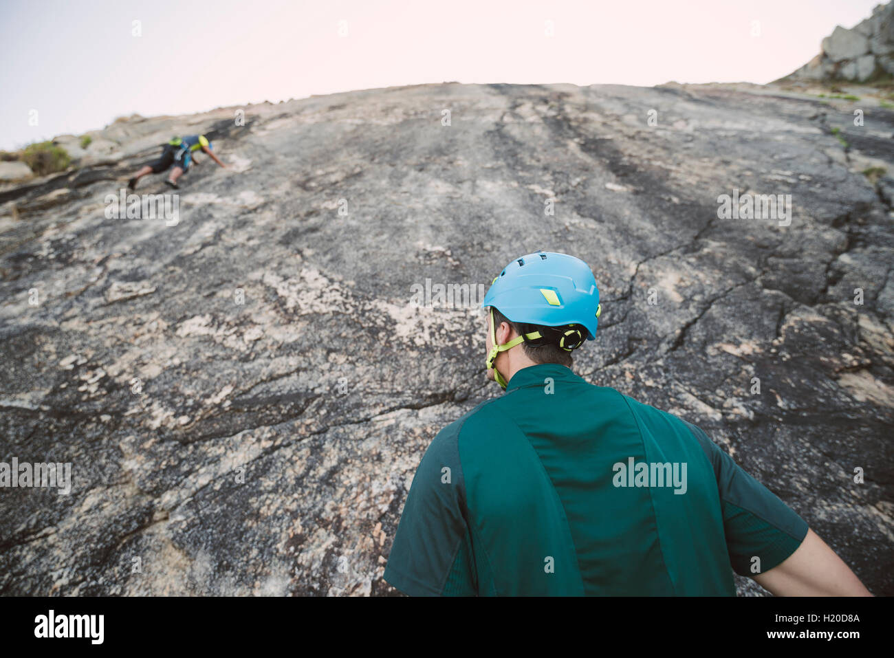 Climber looking up a rock wall Stock Photo - Alamy