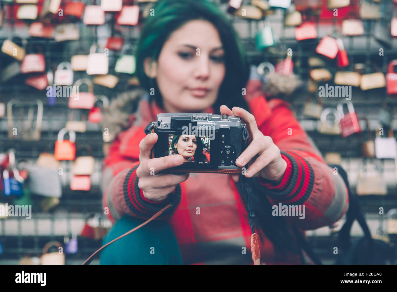 Germany, Cologne, woman taking selfie in front of love locks at ...