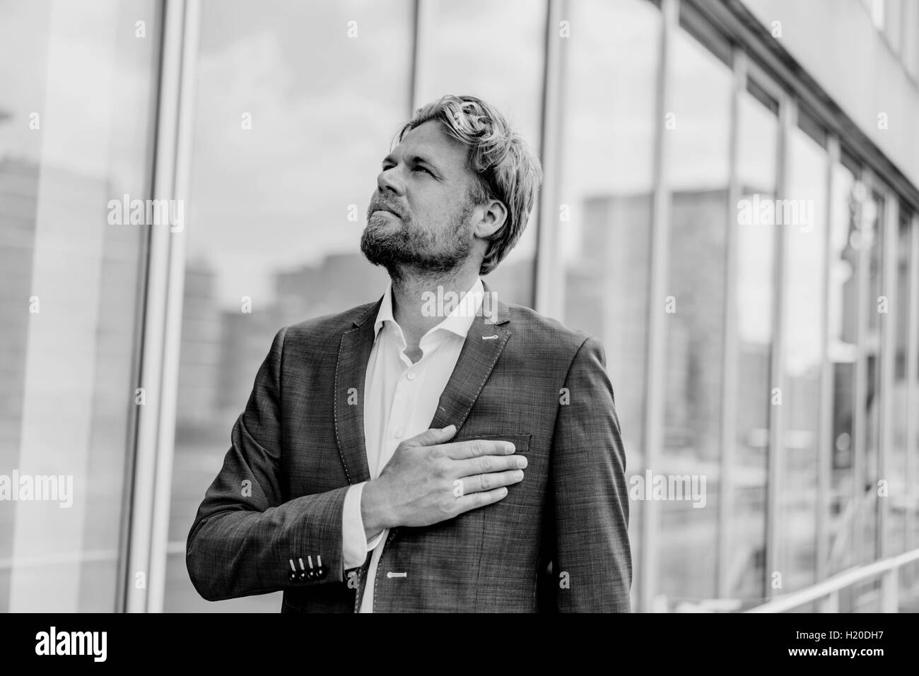 Serious businessman looking up Stock Photo - Alamy