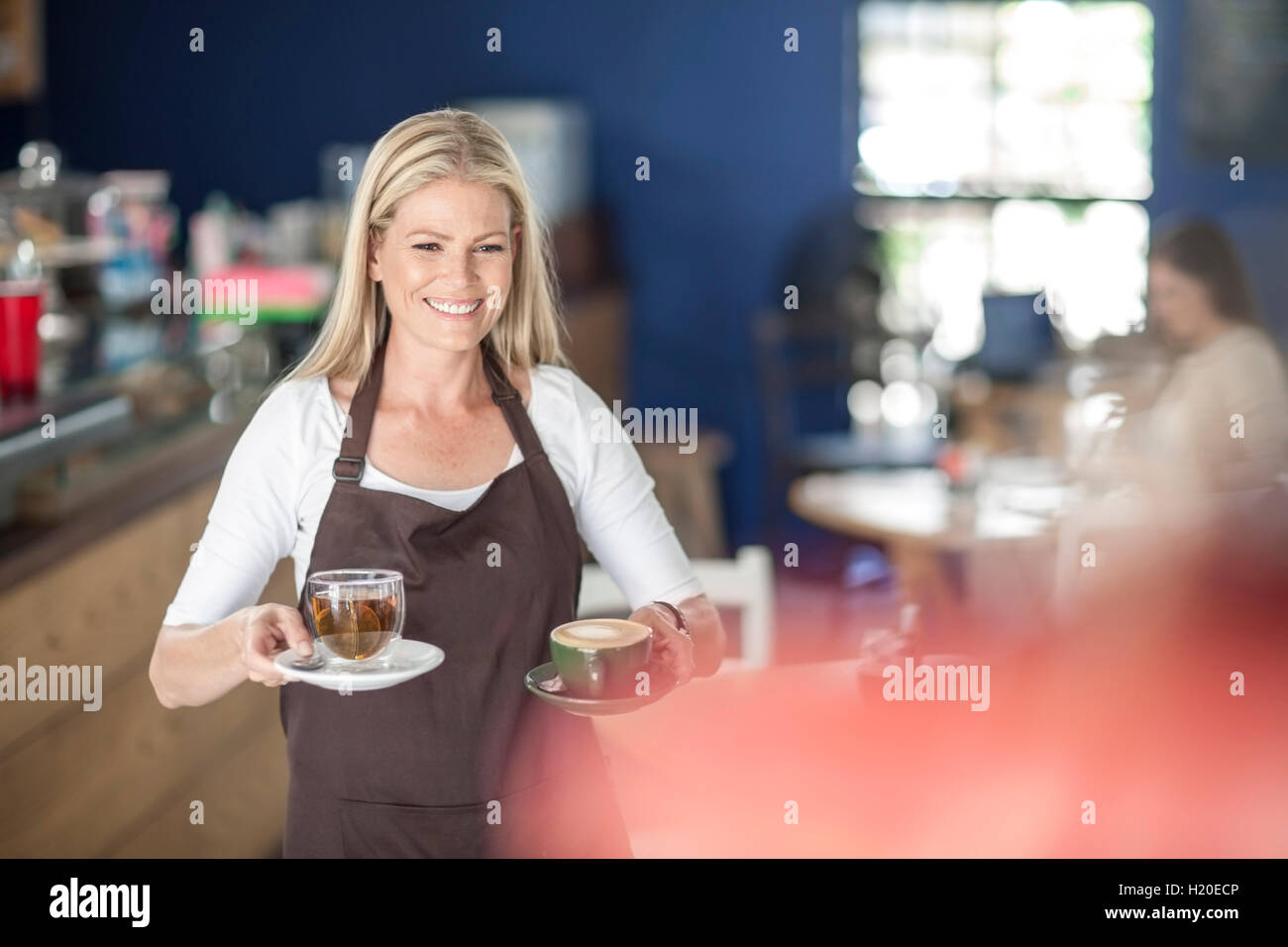 Waitress serving coffee and tea in a cafe Stock Photo - Alamy