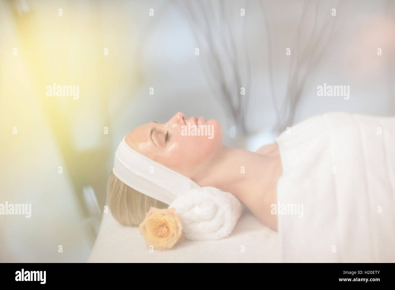 Young woman lying on lounge at spa Stock Photo - Alamy