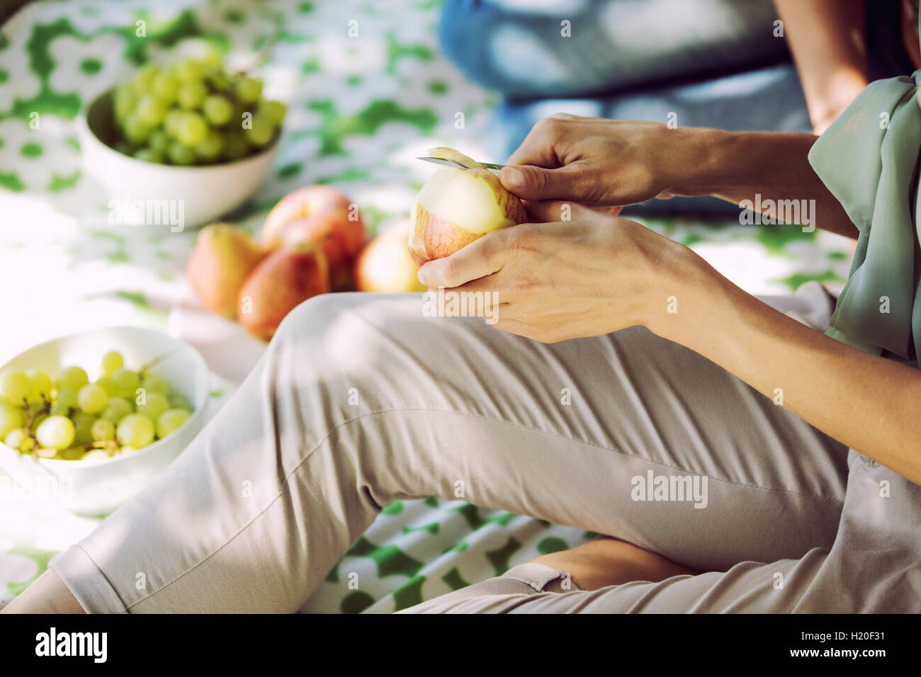 Hands of woman peeling an apple Stock Photo - Alamy